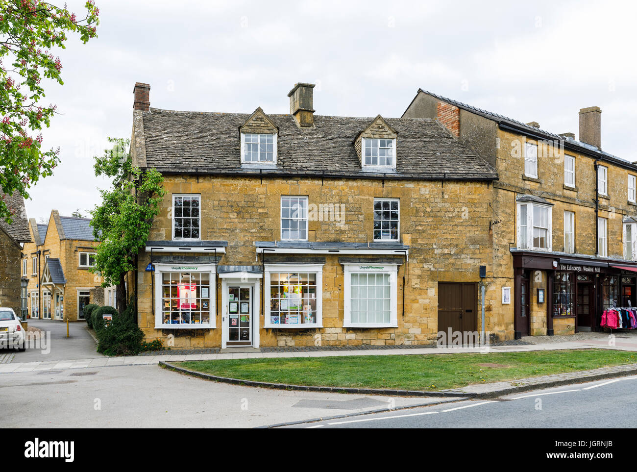 Street scene and roadside shops in typical local Cotswold stone style ...