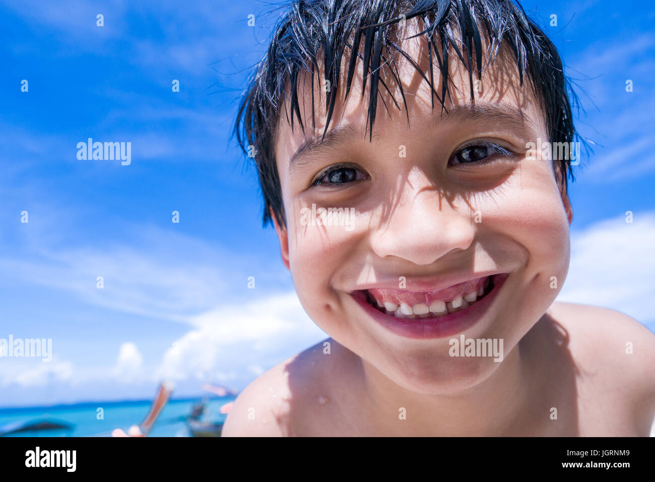 a boy smiling on the beach Stock Photo - Alamy