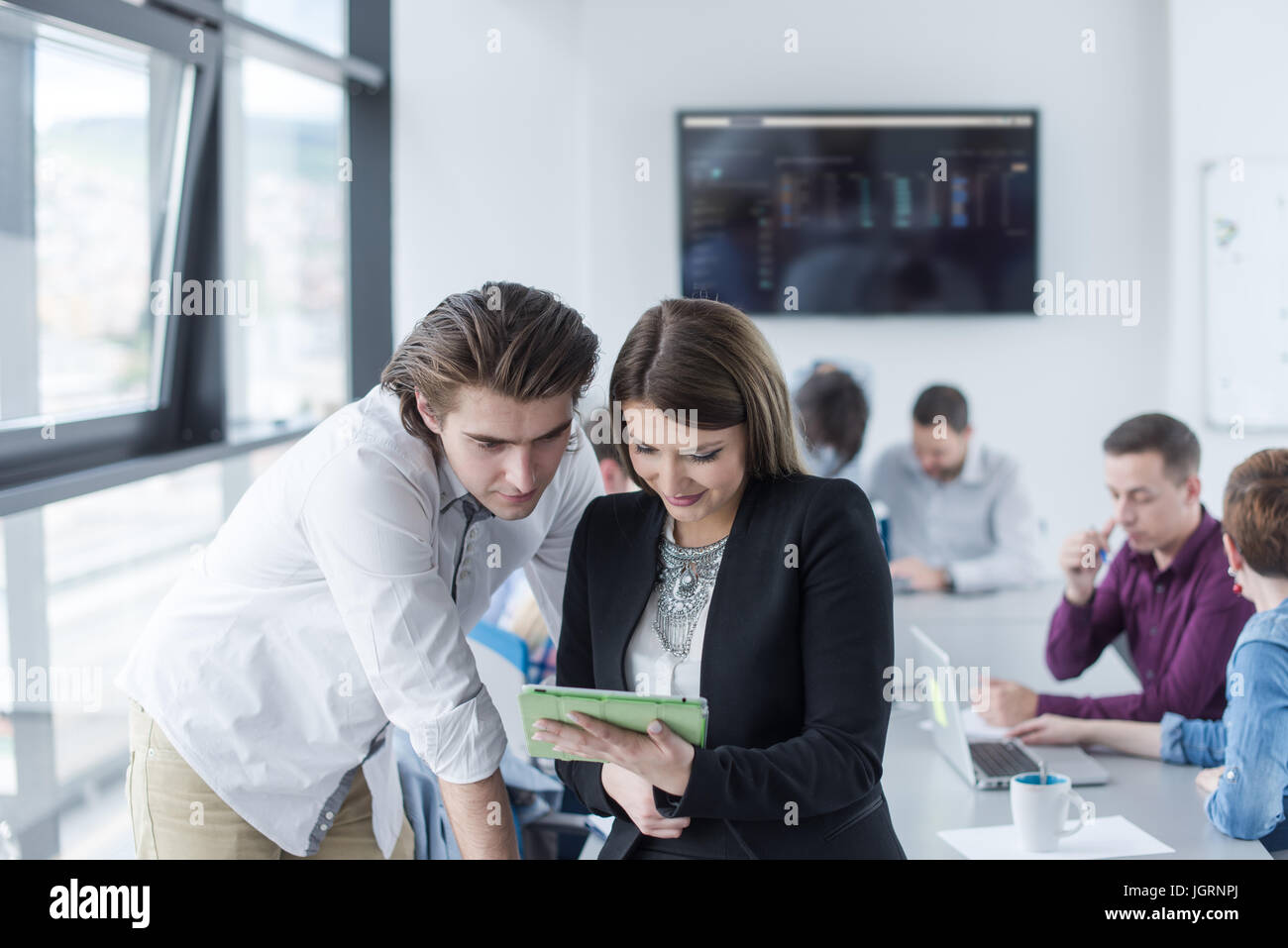 two business people using tablet preparing for next meeting and ...