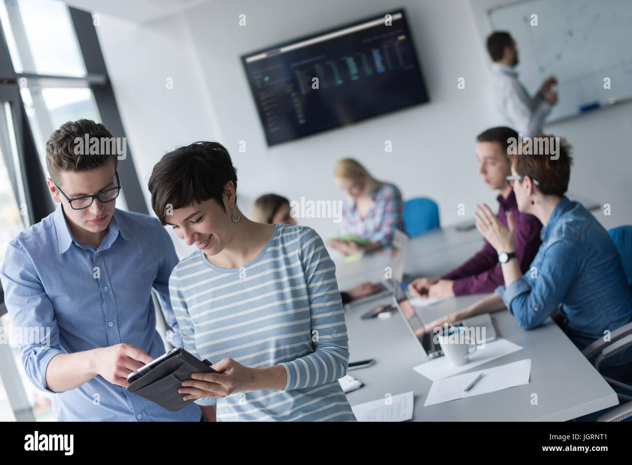 two business people using tablet preparing for next meeting and ...