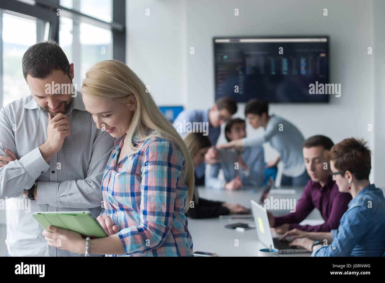 two business people using tablet preparing for next meeting and ...