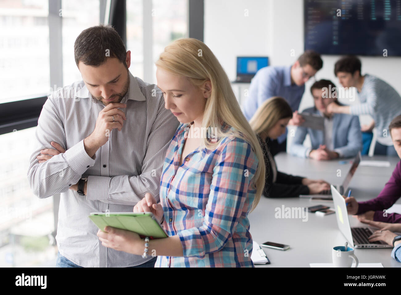 two business people using tablet preparing for next meeting and ...