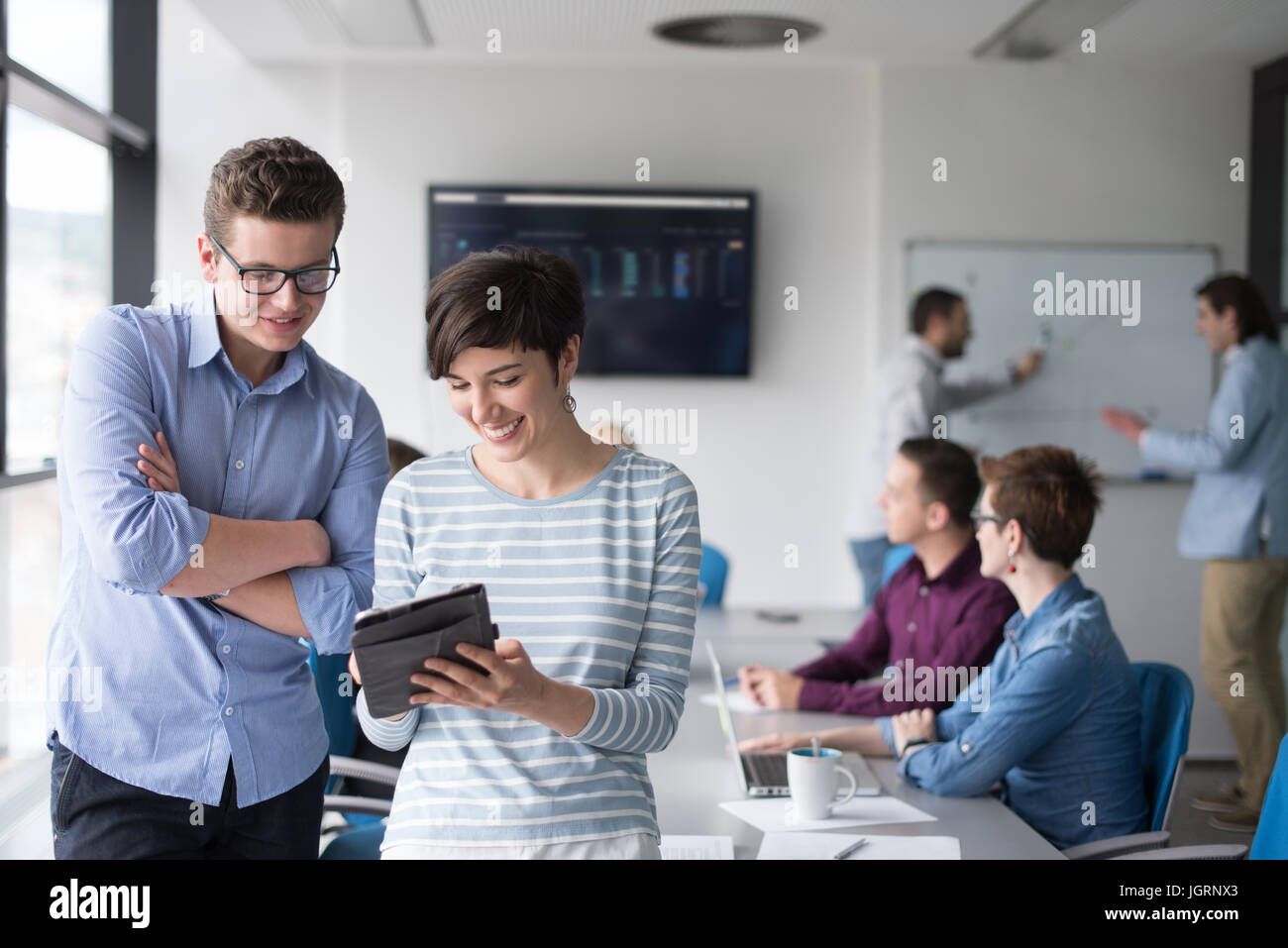 two business people using tablet preparing for next meeting and ...