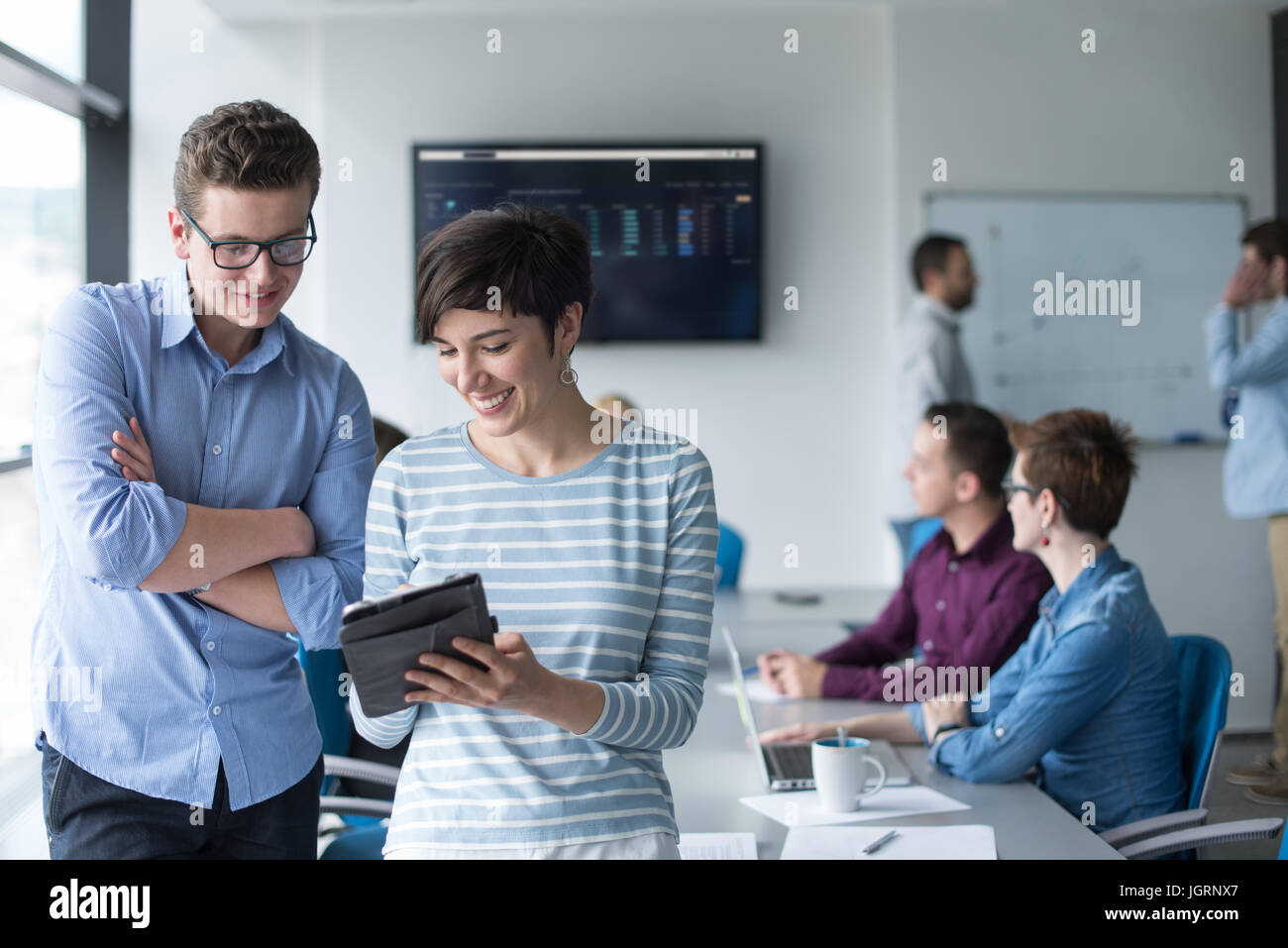 two business people using tablet preparing for next meeting and ...