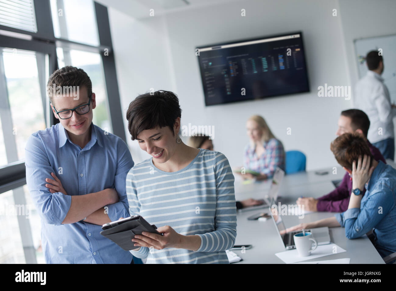 two business people using tablet preparing for next meeting and ...