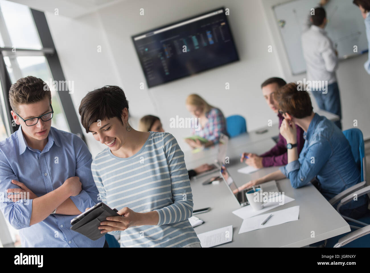 two business people using tablet preparing for next meeting and ...