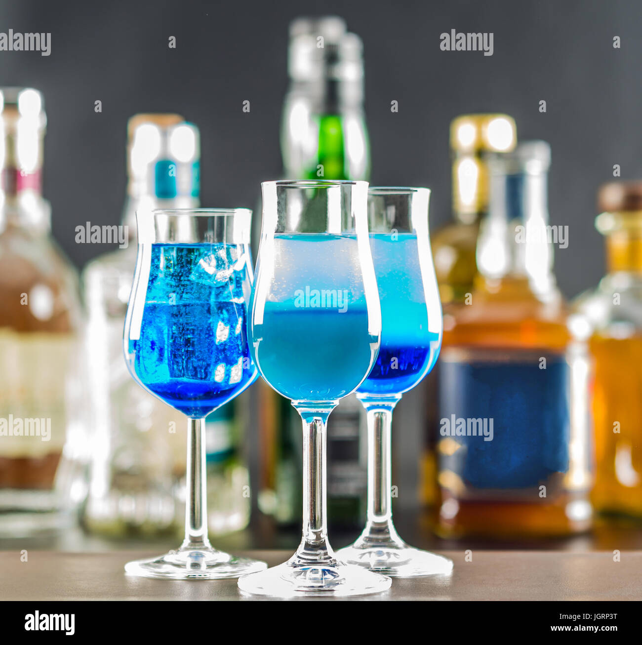 Colorful drink on the background of bottles in original shapes ...