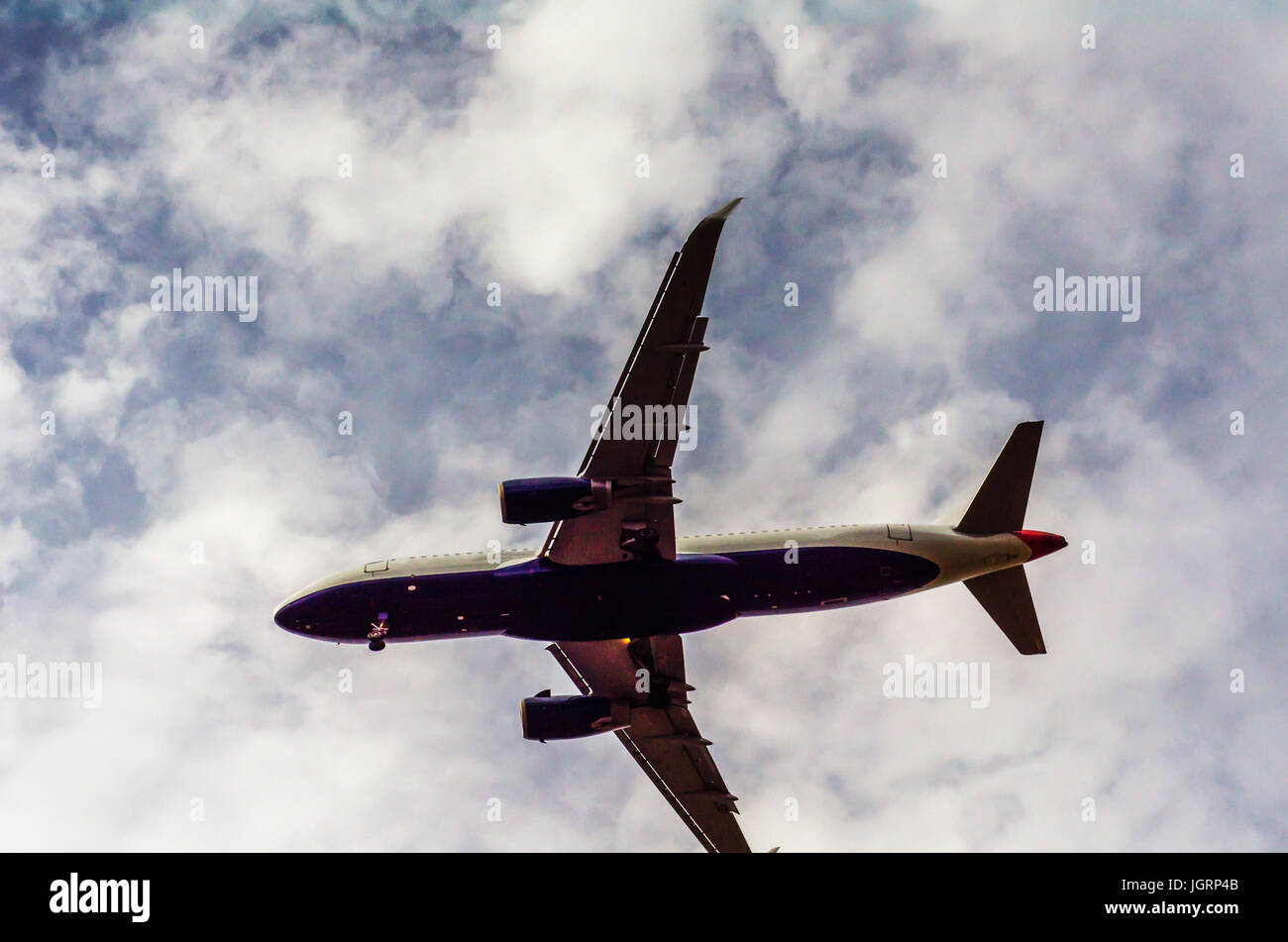 Passenger plane flying in the blue sky with clouds, cruise aircraft ...