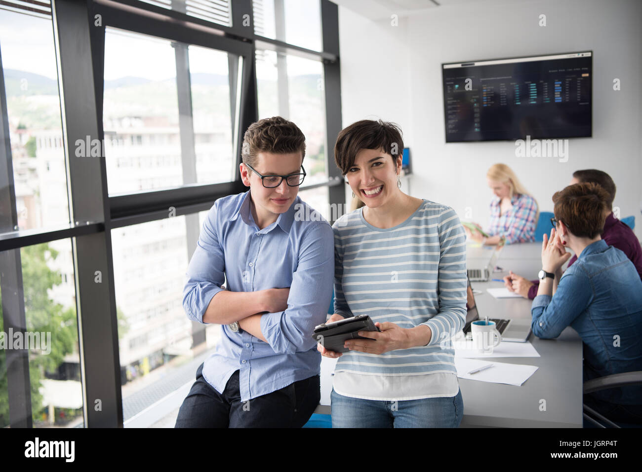 two business people using tablet preparing for next meeting and ...