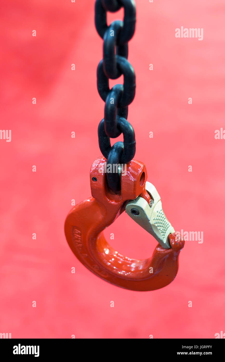 Industrial black Steel Chain with red hook in red background Stock ...