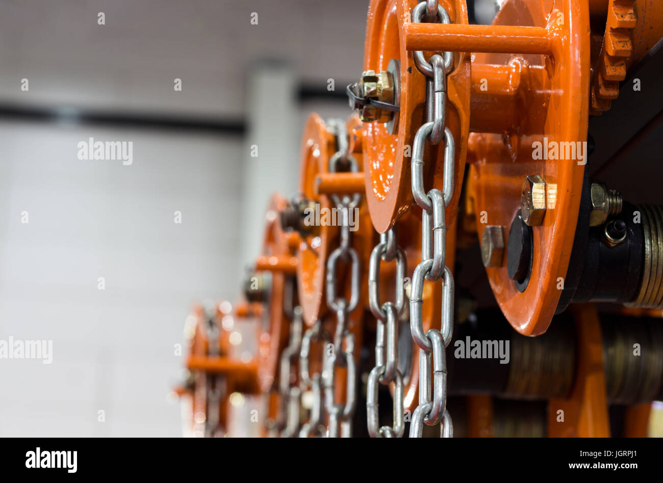 Industrial Steel Chains in orange hoists ; Selective focus Stock Photo ...