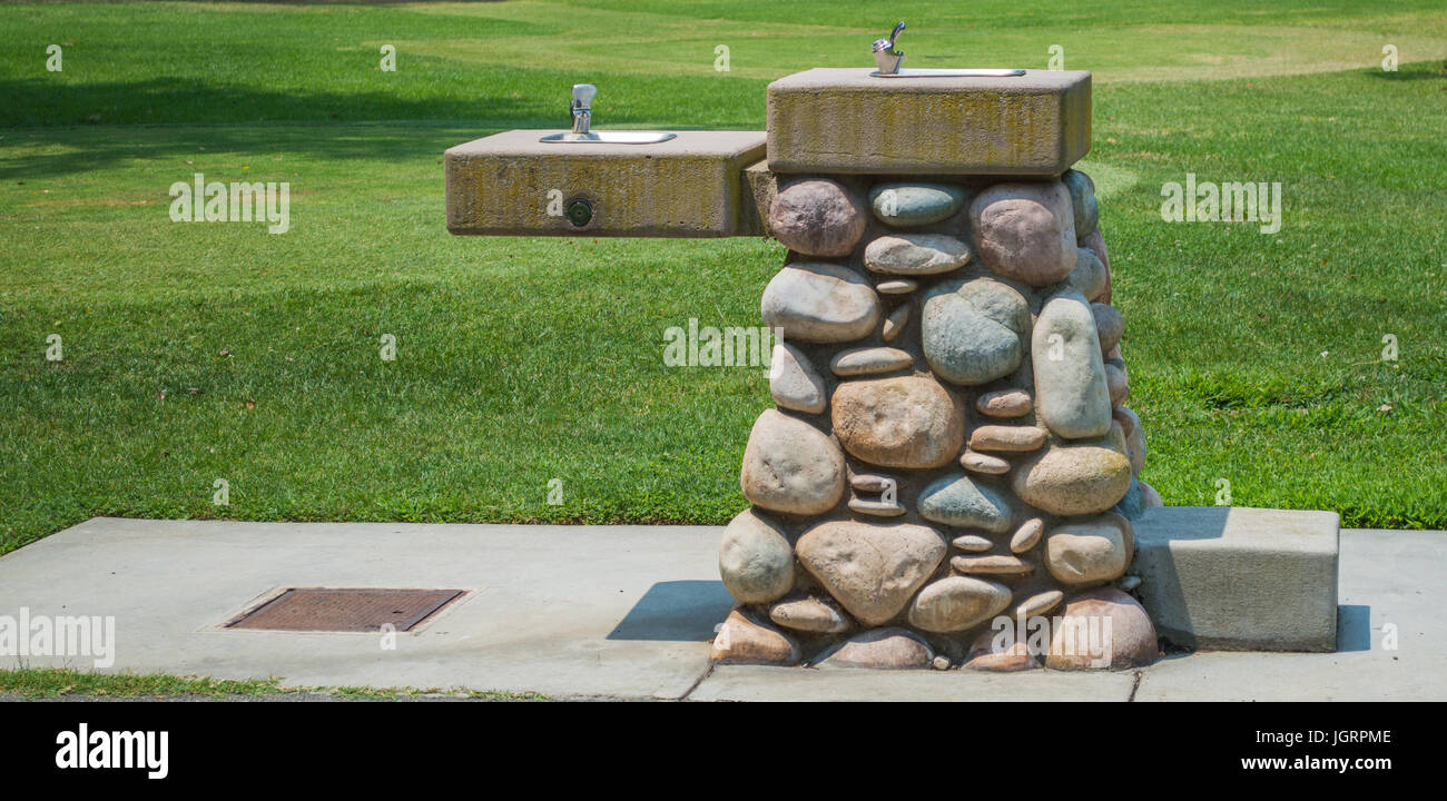 stone double water fountain in a park Stock Photo - Alamy