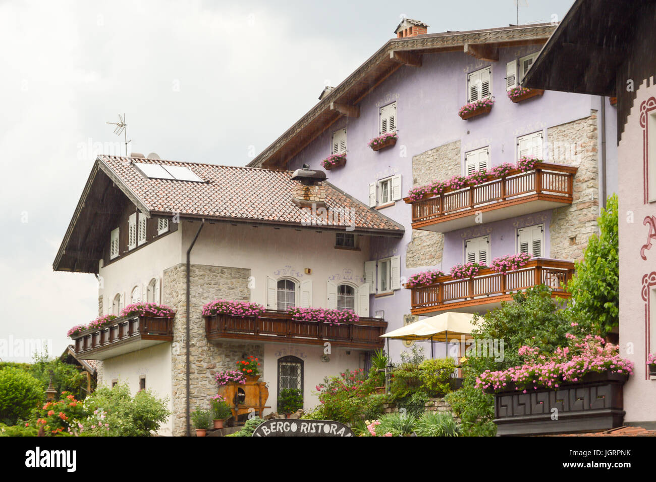 Mauve colored building with several balconies flourished in the ...
