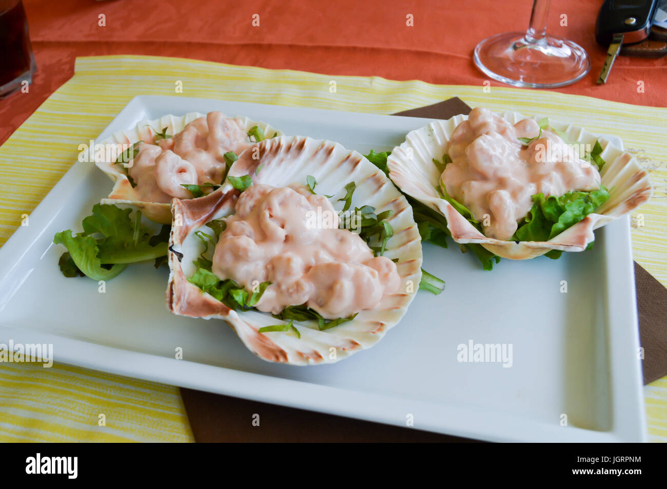 Cocktail of pink shrimp served in scallops in the dolomites in Italy ...