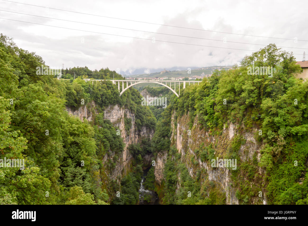 Bridge with an arch between two rock walls and over a river in the ...