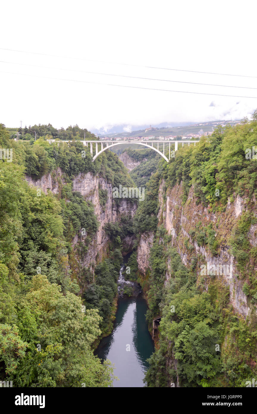 Bridge with an arch between two rock walls and over a river in the ...