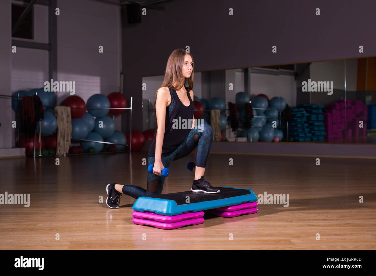 Sporty woman using step platform Stock Photo - Alamy