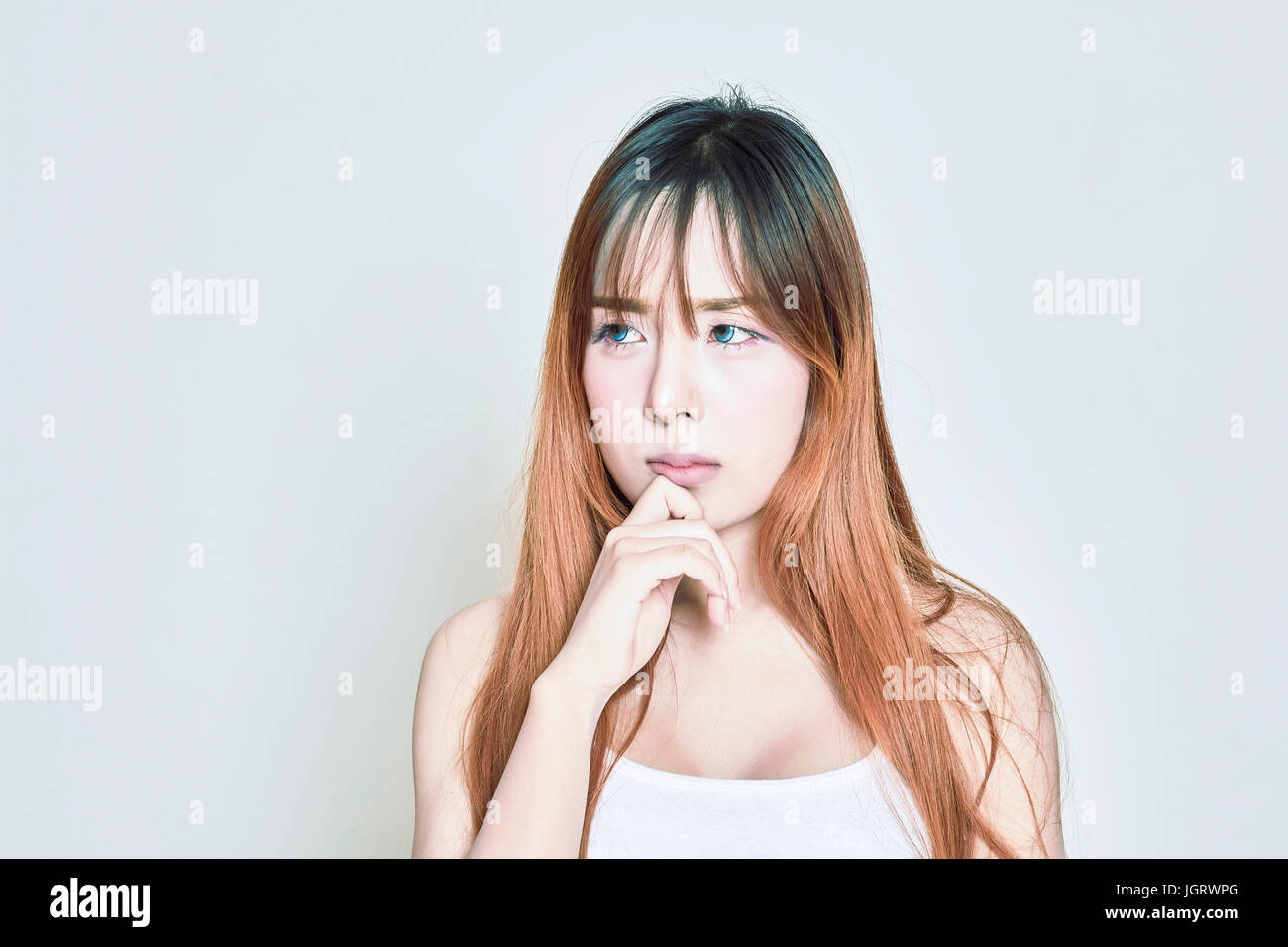 Asian woman is thinking Stock Photo - Alamy