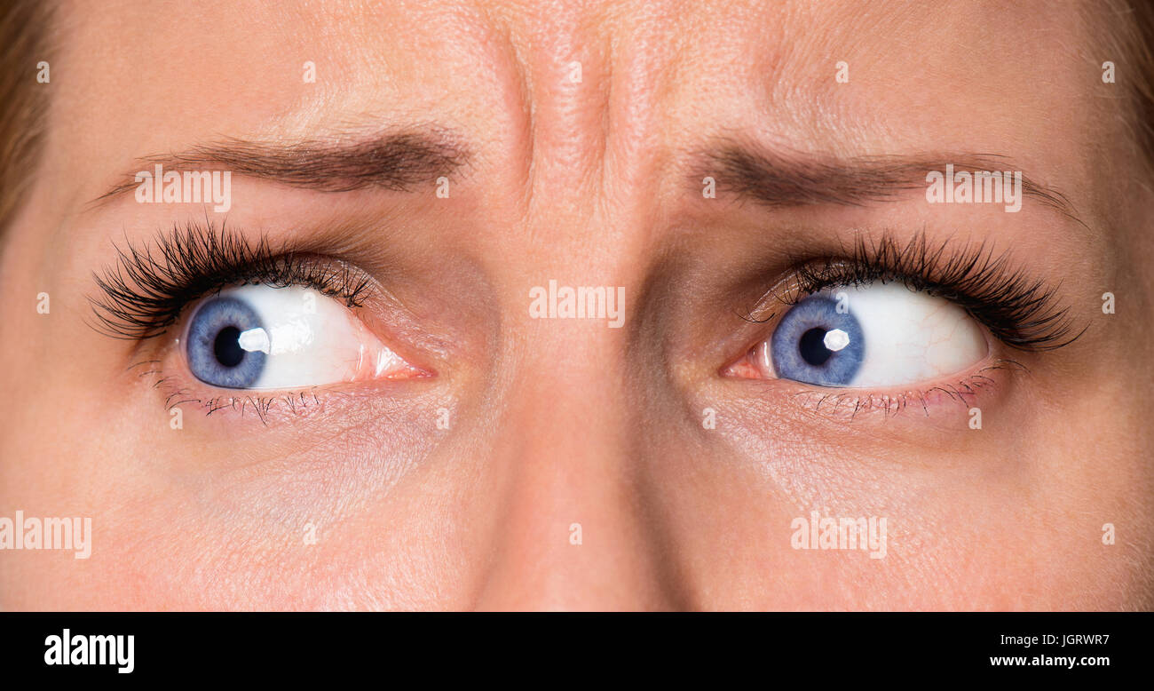 Close-up scared face of beautiful young woman with beautiful blue eyes ...