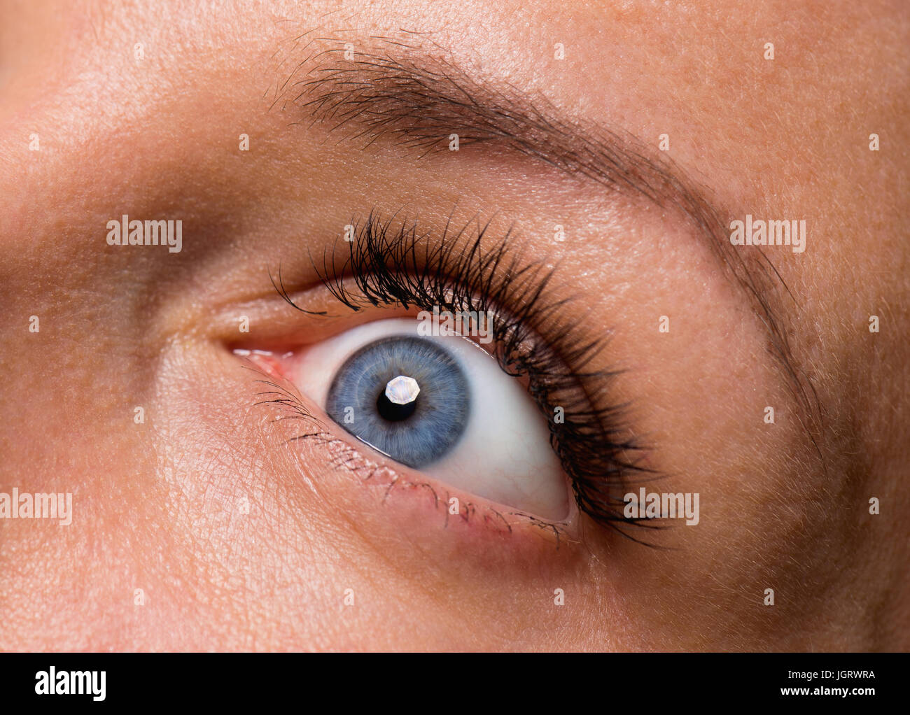 Close-up scared face of beautiful young woman with beautiful blue eyes ...