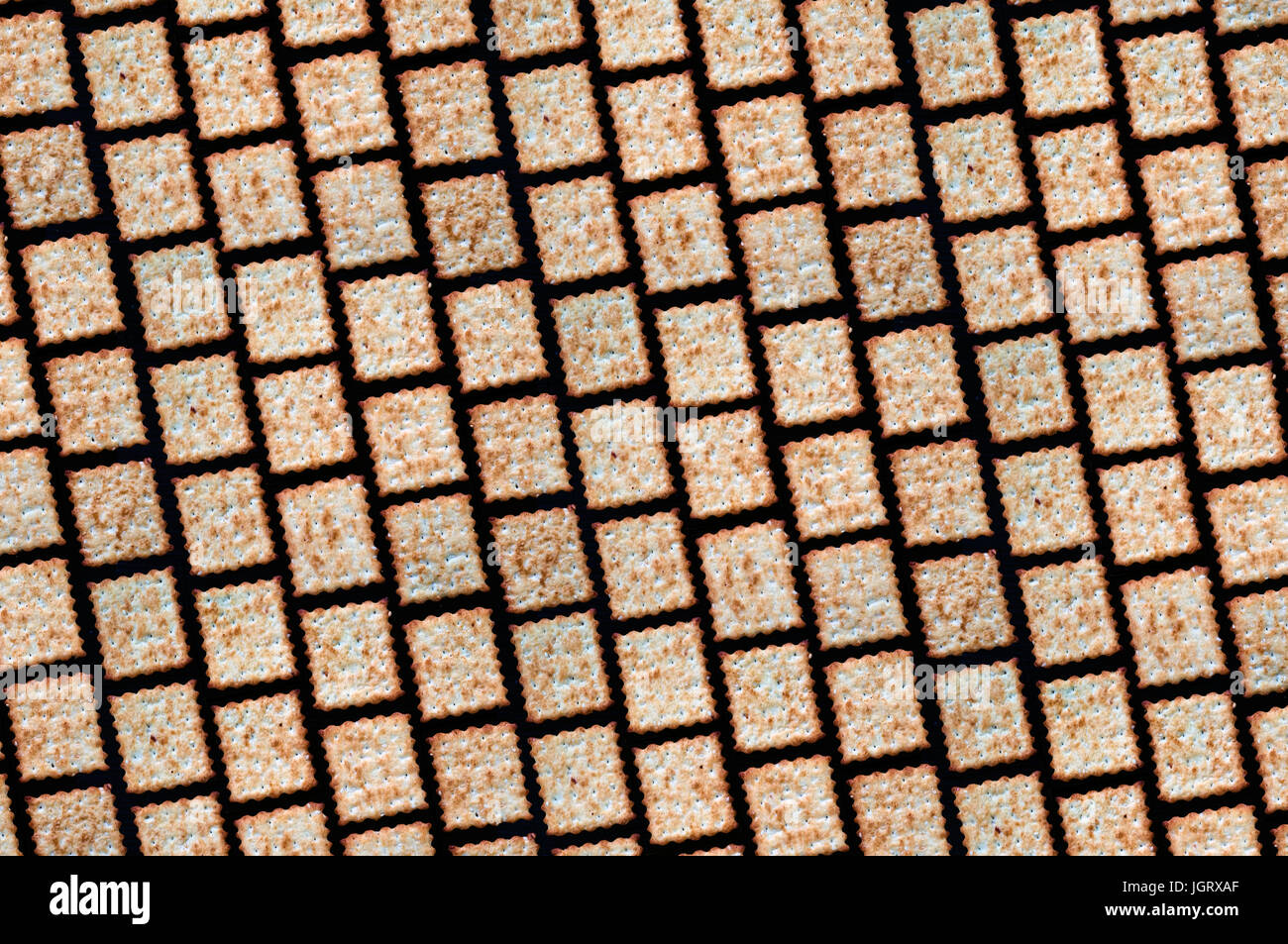 Background of the rectangular square pretzels on a black background. A ...