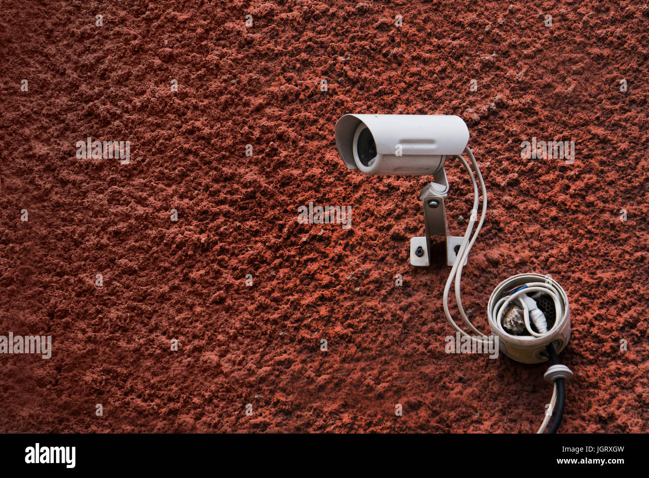 CCTV security camera and dark red wall with white wires. Security ...