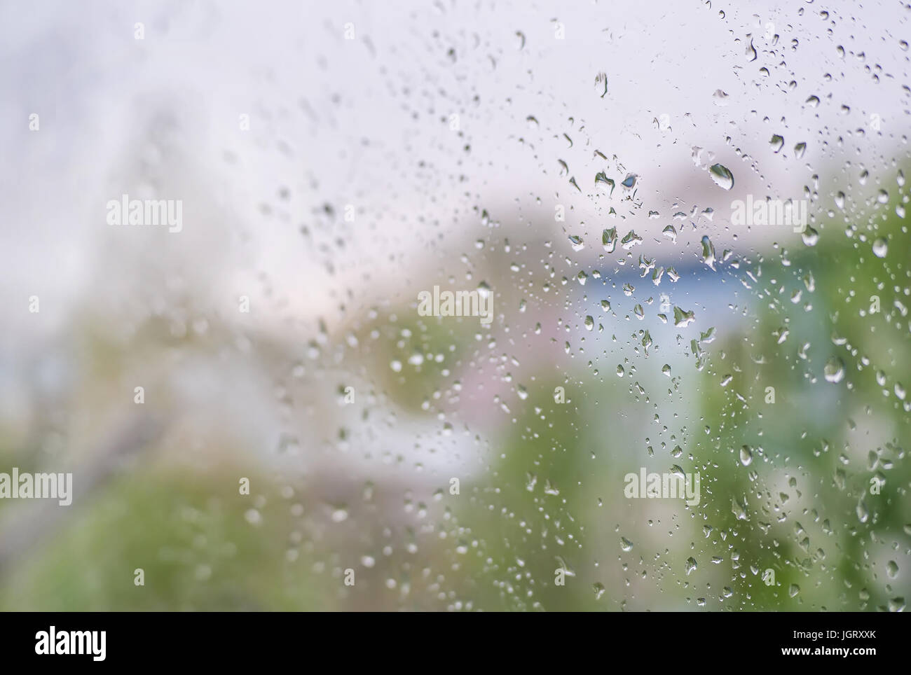 Rain drops on glass window. A sad sad concept, bad weather outside the ...