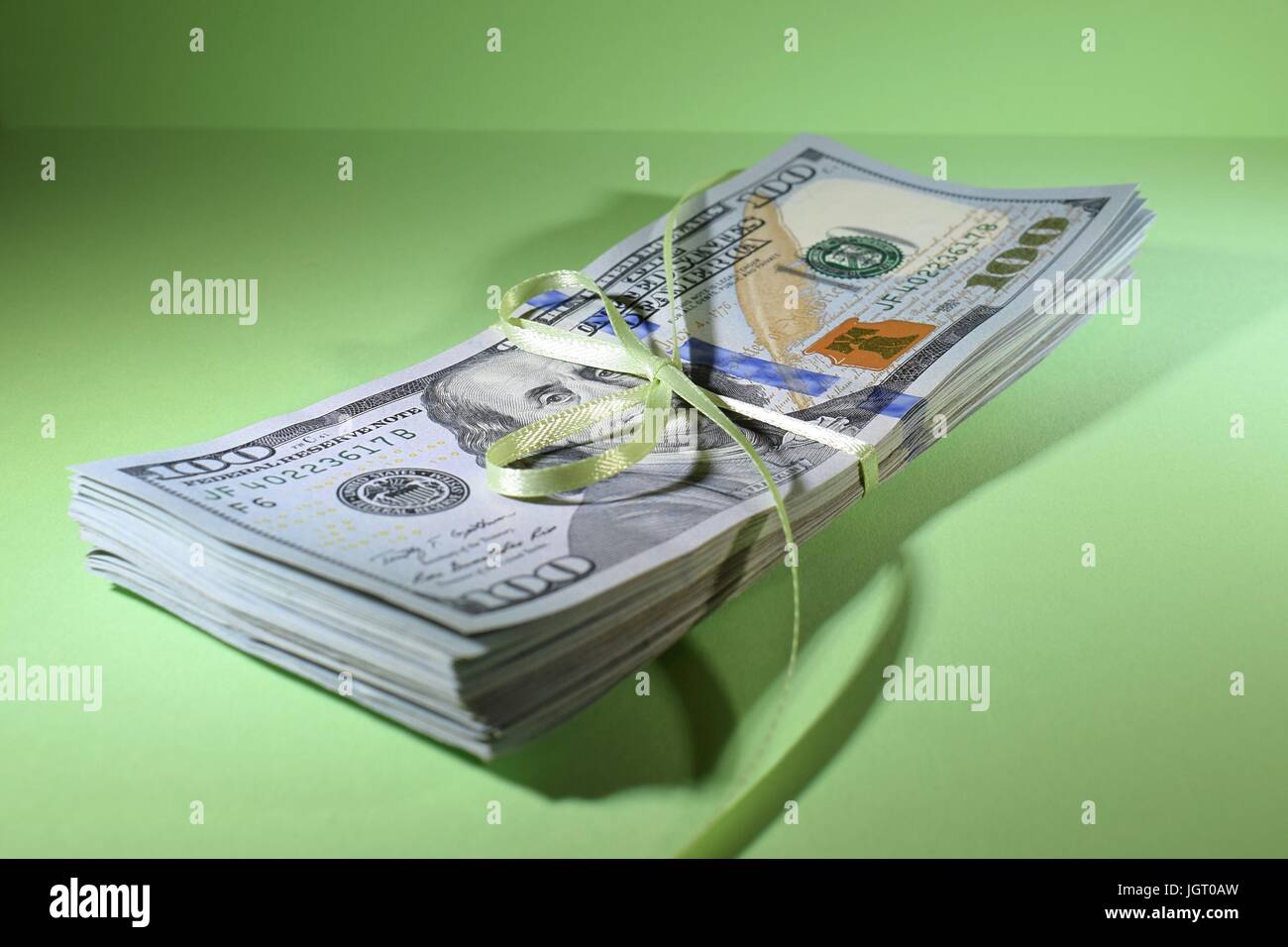 A tidy single stack of new hundred dollar bills American $100 USD cash ...