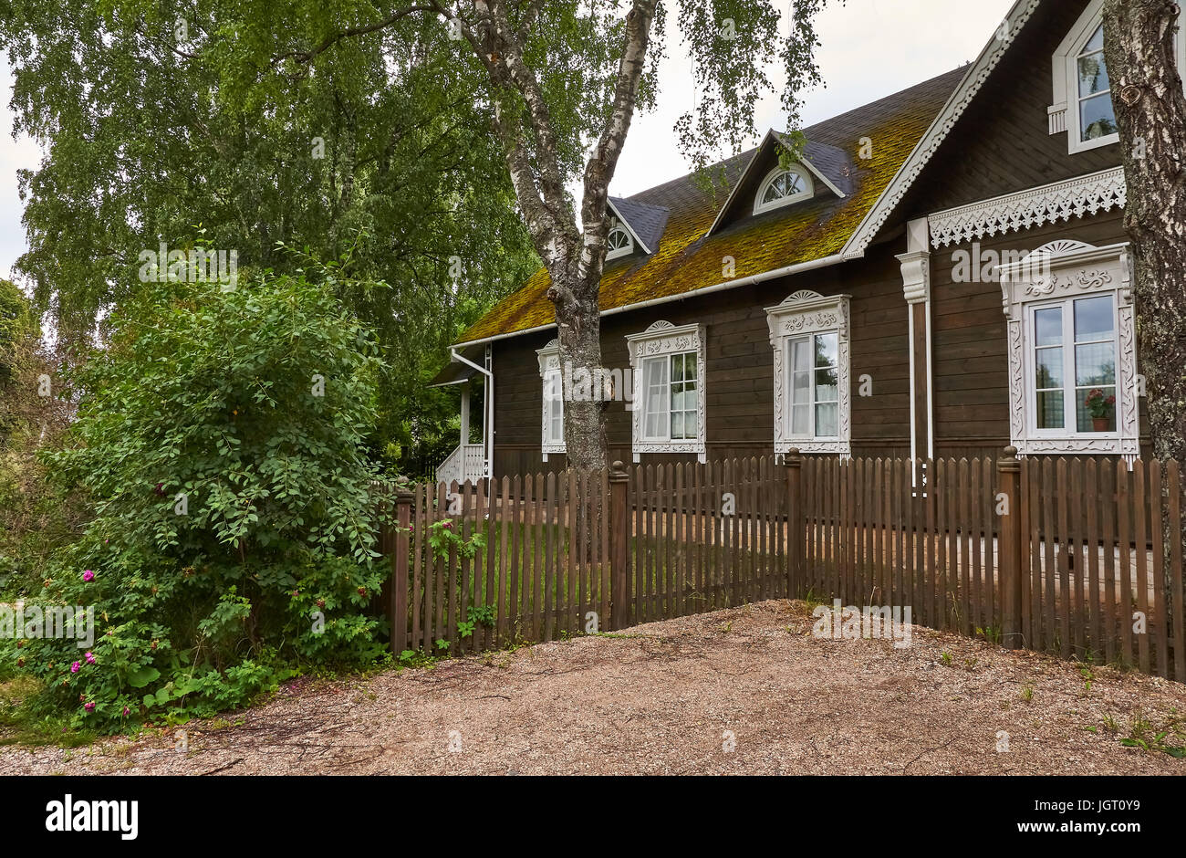 Rural landscape. A wooden rural house with a roof covered with moss. In ...