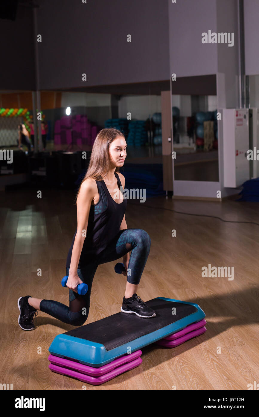 Sporty woman using step platform Stock Photo - Alamy