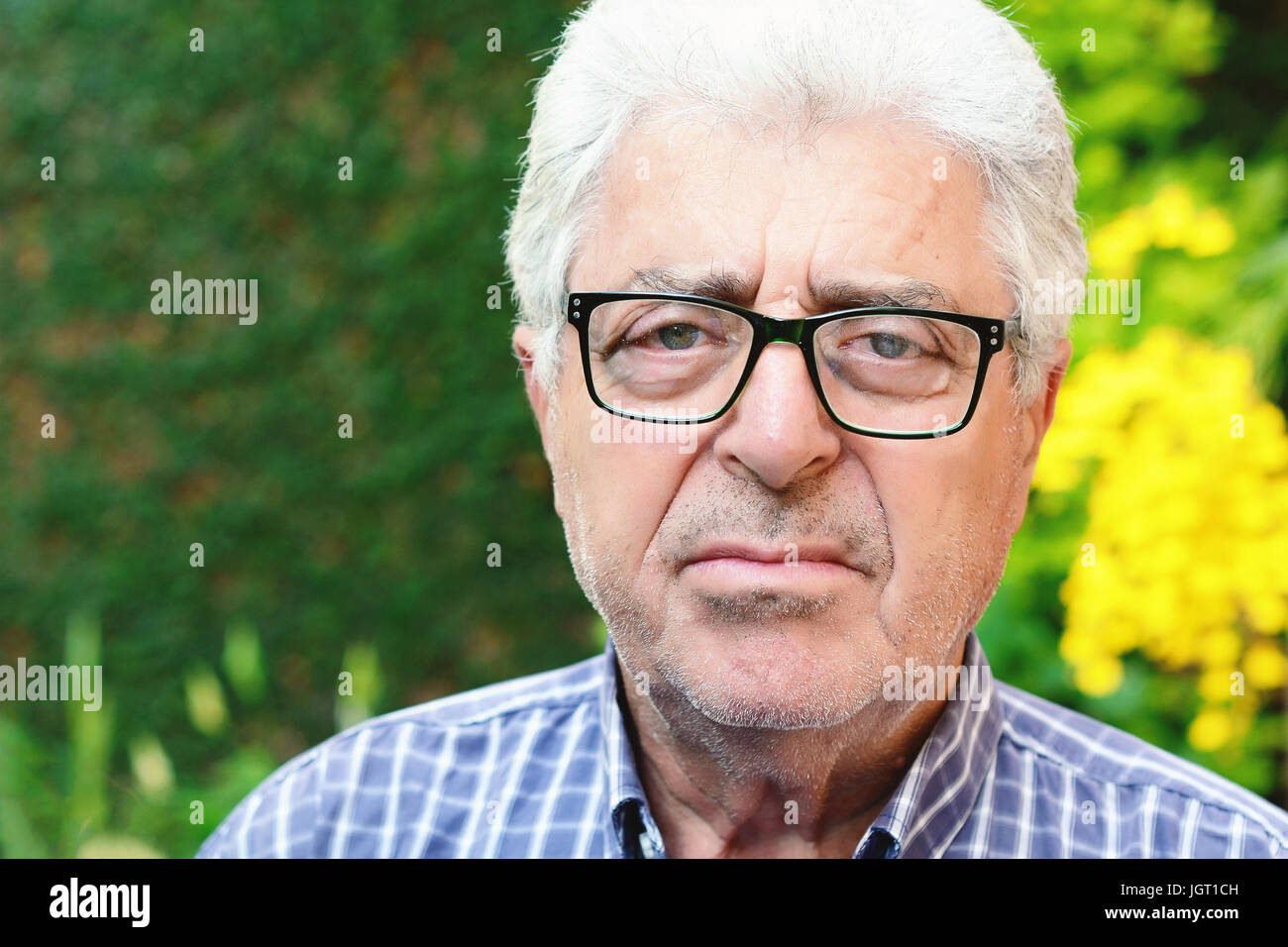 Portrait of an old man sitting outside. Outdoors Stock Photo - Alamy