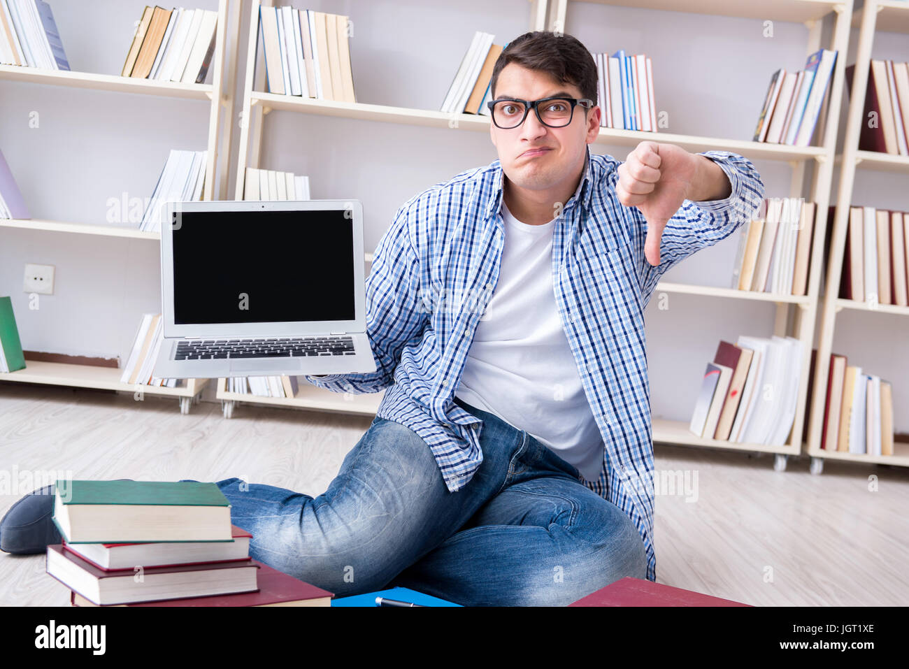 Young student studying with books Stock Photo - Alamy