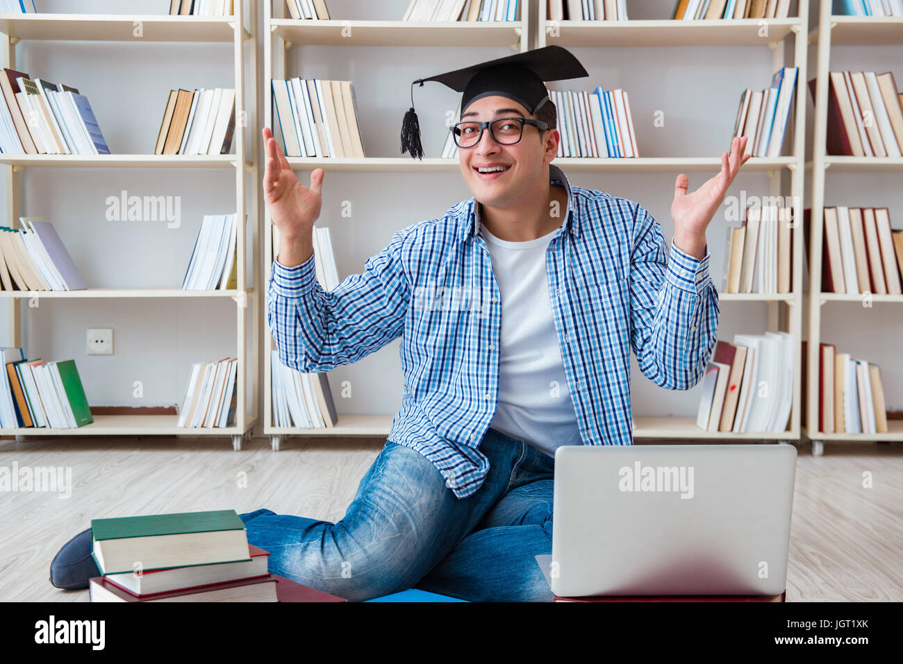 Young student studying with books Stock Photo - Alamy