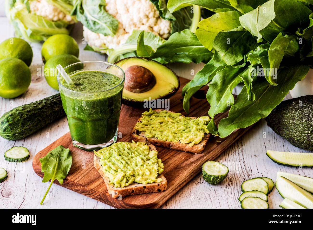 green smoothie and two sandwiches with avocado. healthy vegan food ...