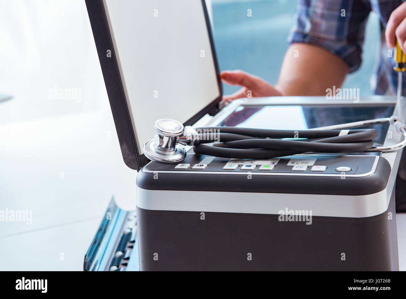 Repairman repairing broken color printer Stock Photo - Alamy