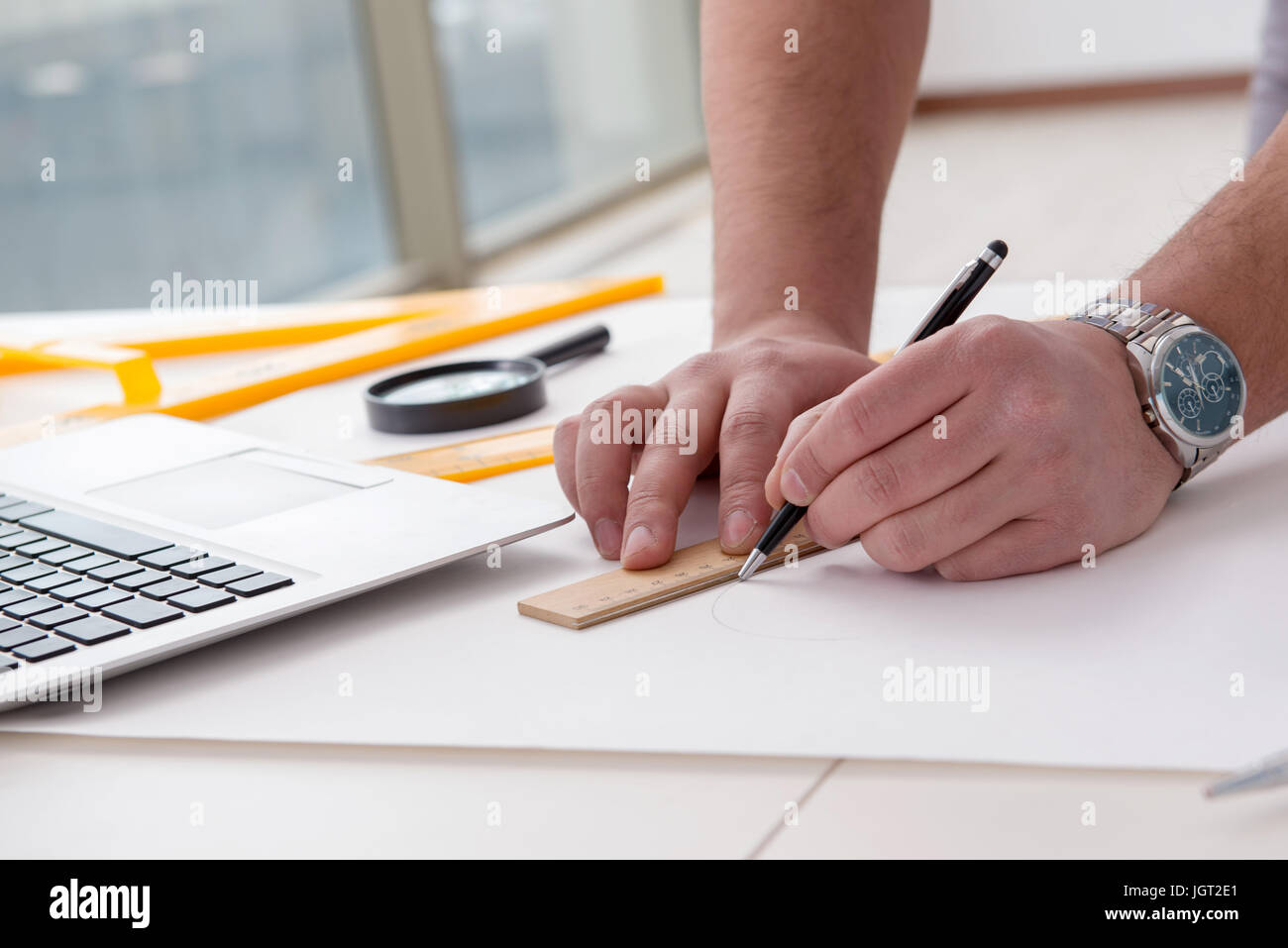 Male engineer working on drawings and blueprints Stock Photo - Alamy