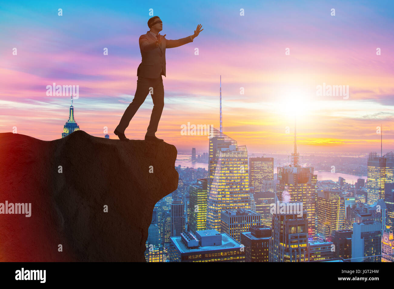Blindfold businessman standing on tip of cliff Stock Photo - Alamy