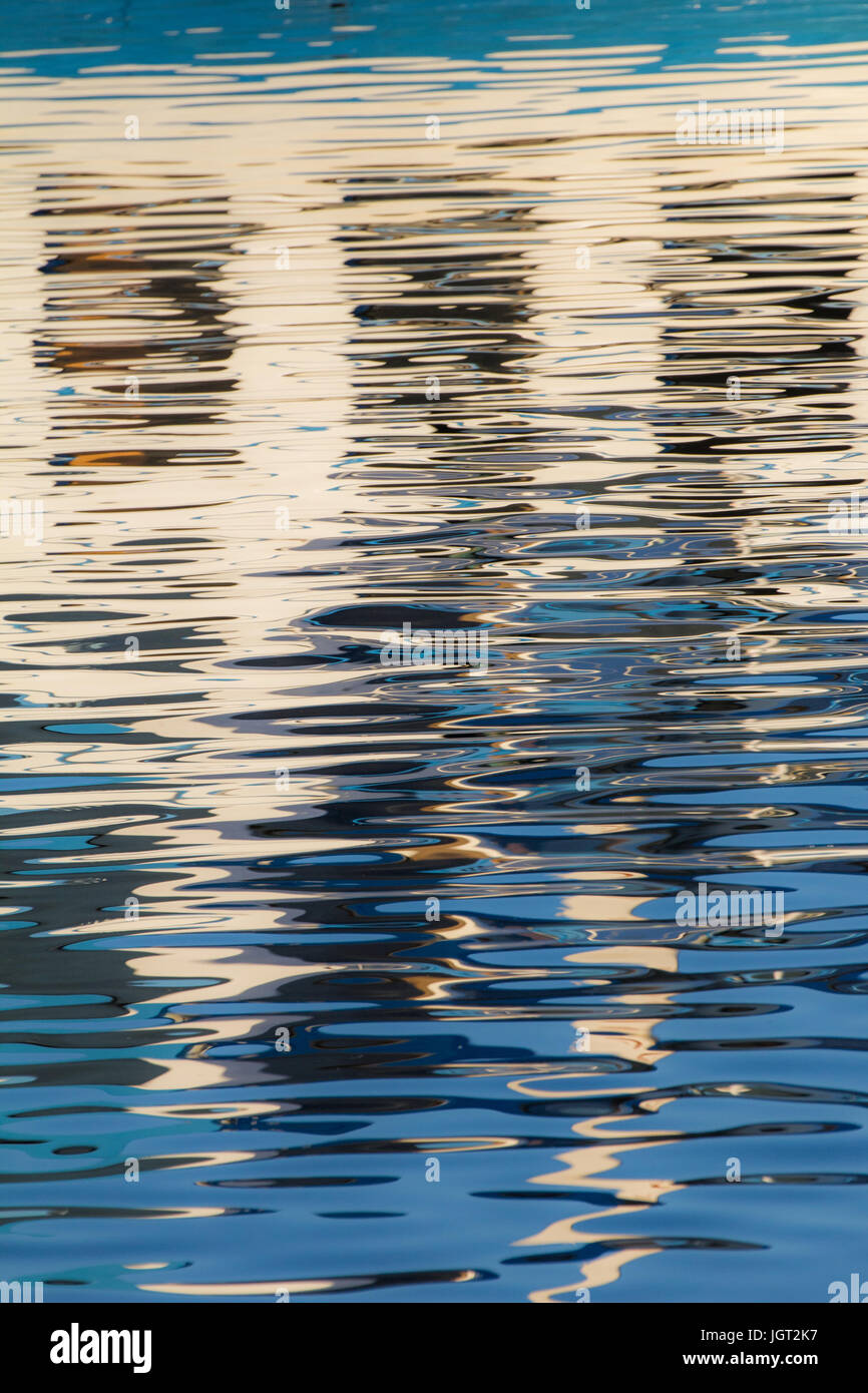 Reflection of windows in the waters of lake created by the light of the ...