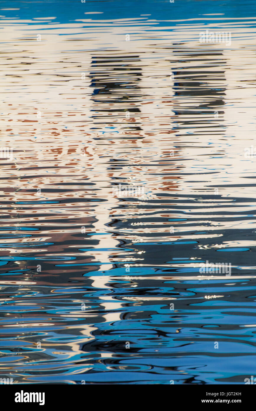Reflection of windows in the waters of lake created by the light of the ...