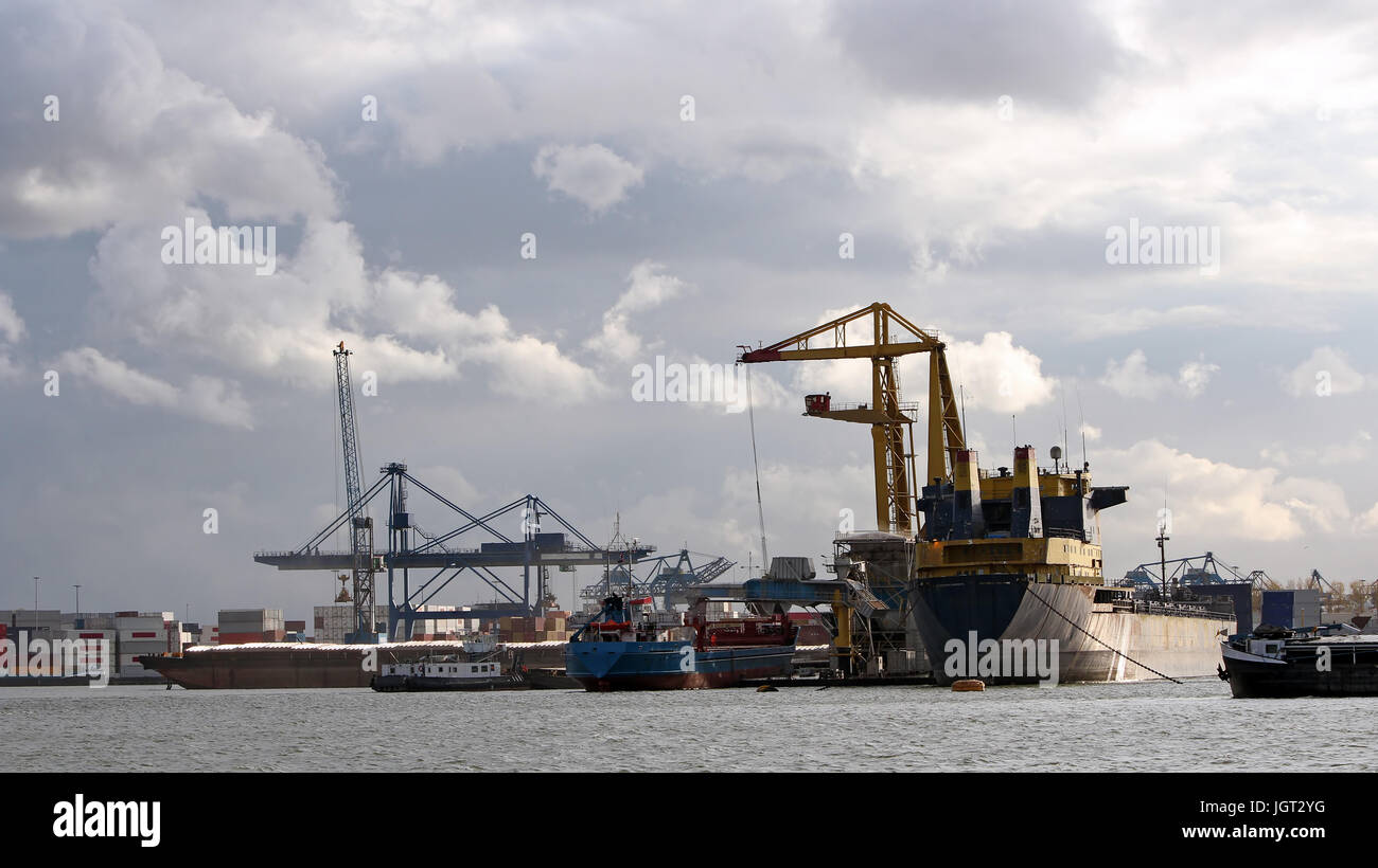Cranes and cargo containers alongside container ships moored at ...