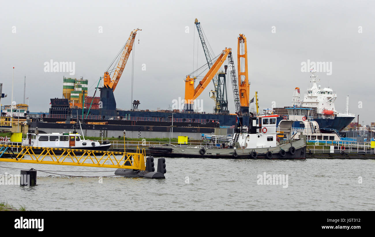 A large bulk carrier loaded with ship cranes. Ship in cargo port ...
