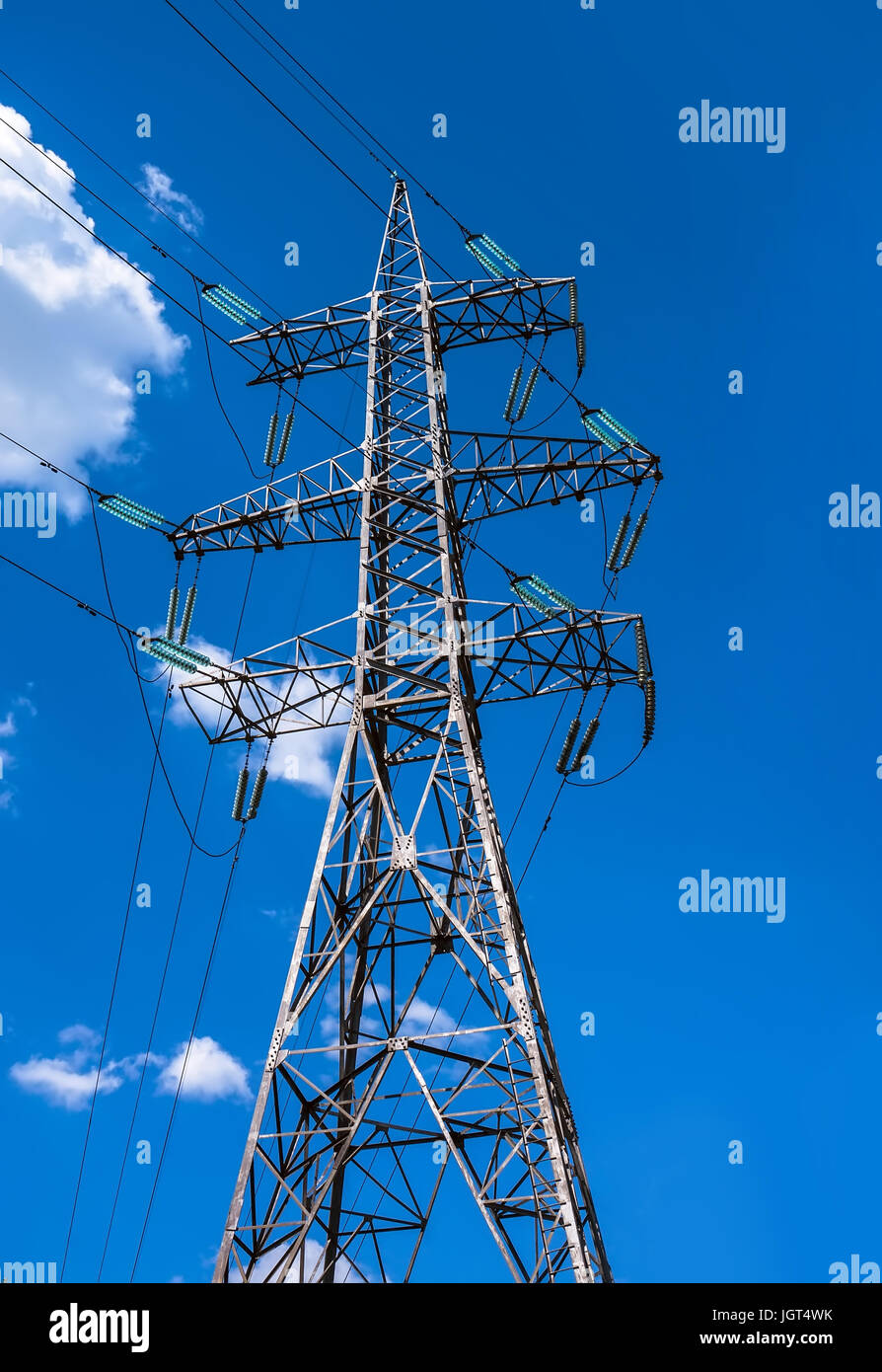 Power tower with electric wires transmitting electricity on blue sky ...