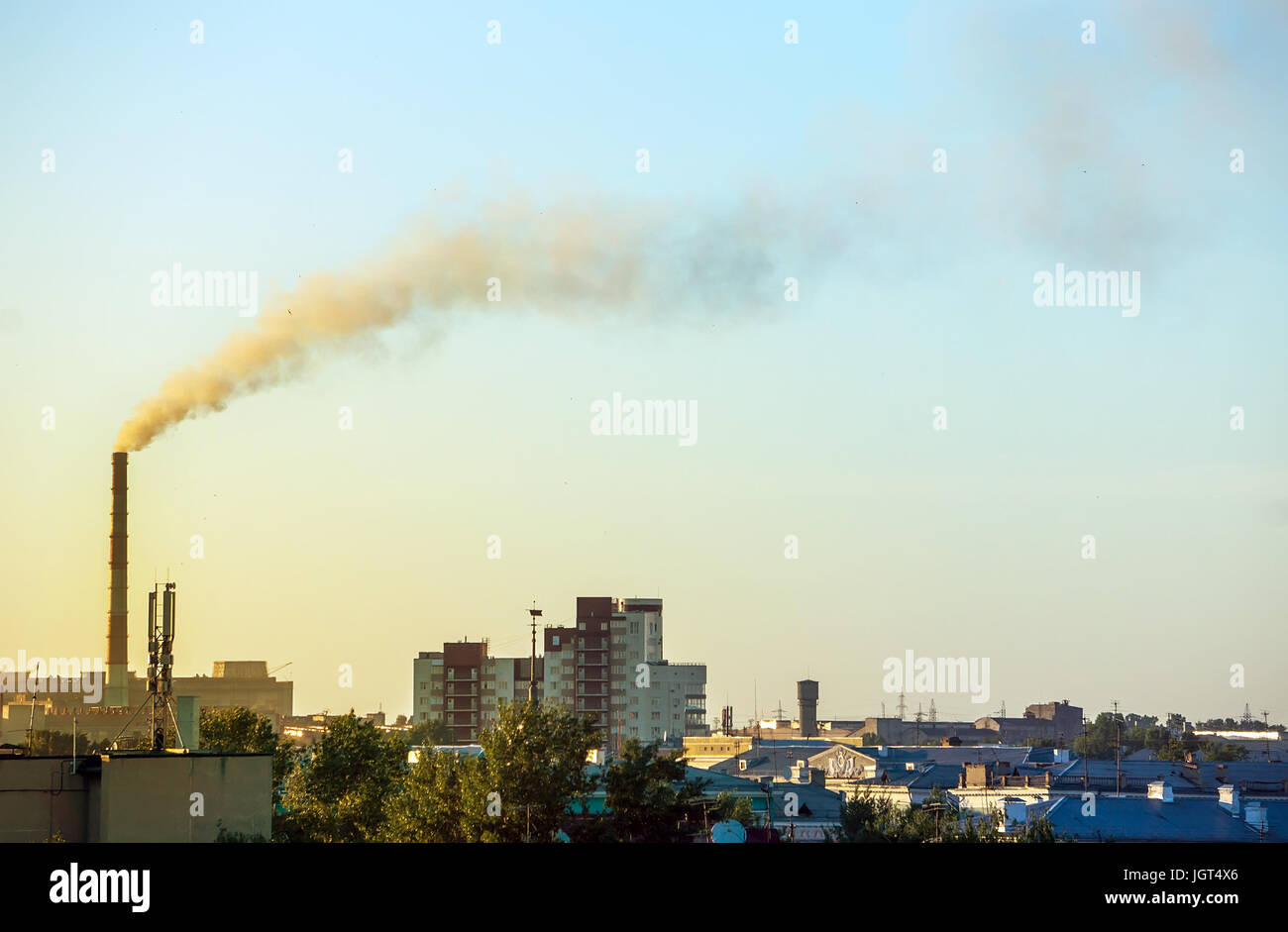 smoke from an industrial pipe on a city. bad ecology, pollution of the ...