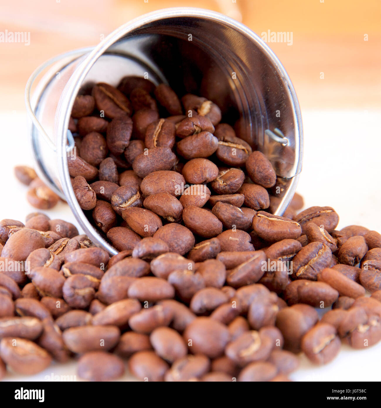 Coffee beans spilt from a bucket Stock Photo - Alamy