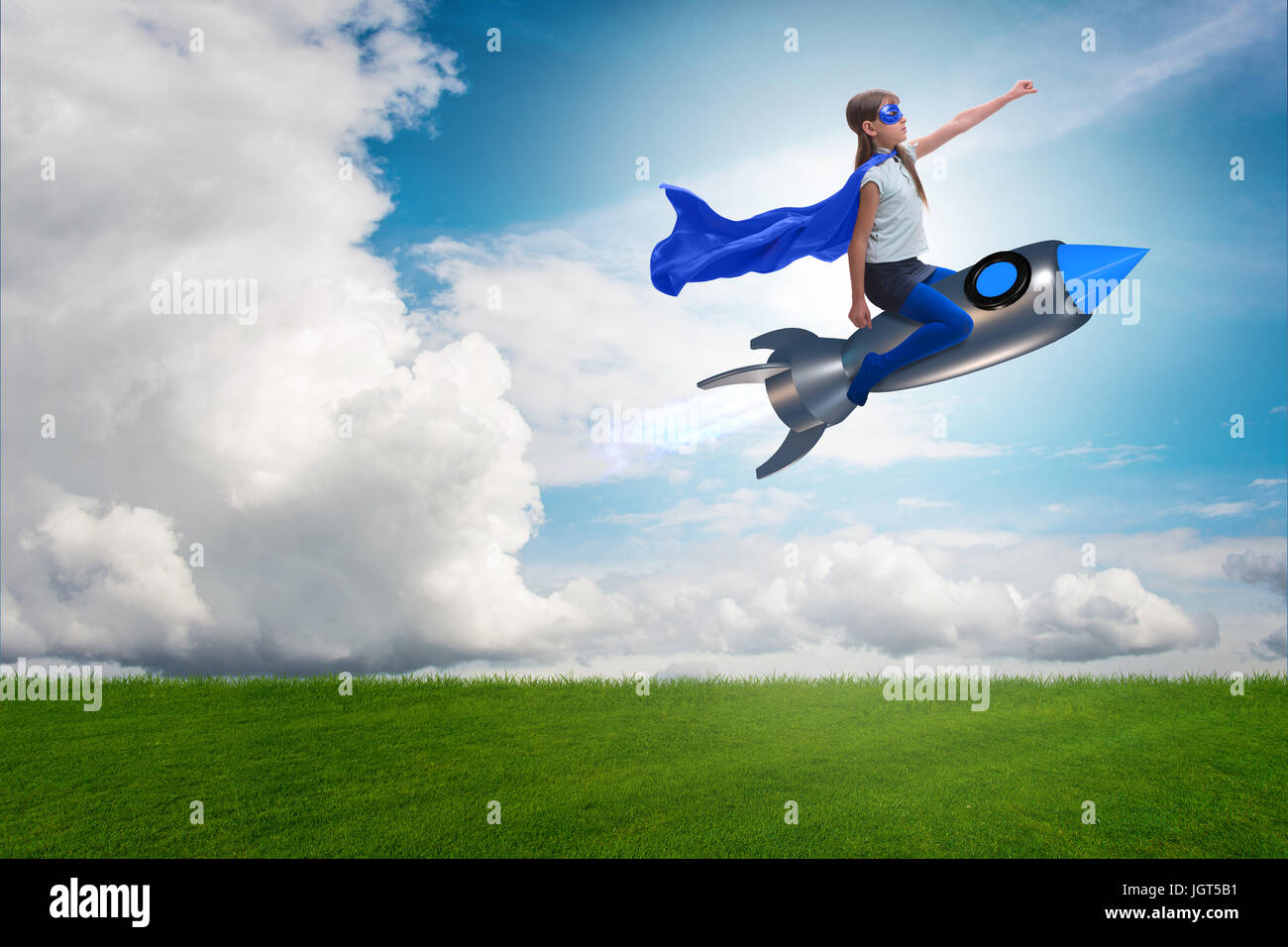 Little girl flying rocket in superhero concept Stock Photo - Alamy