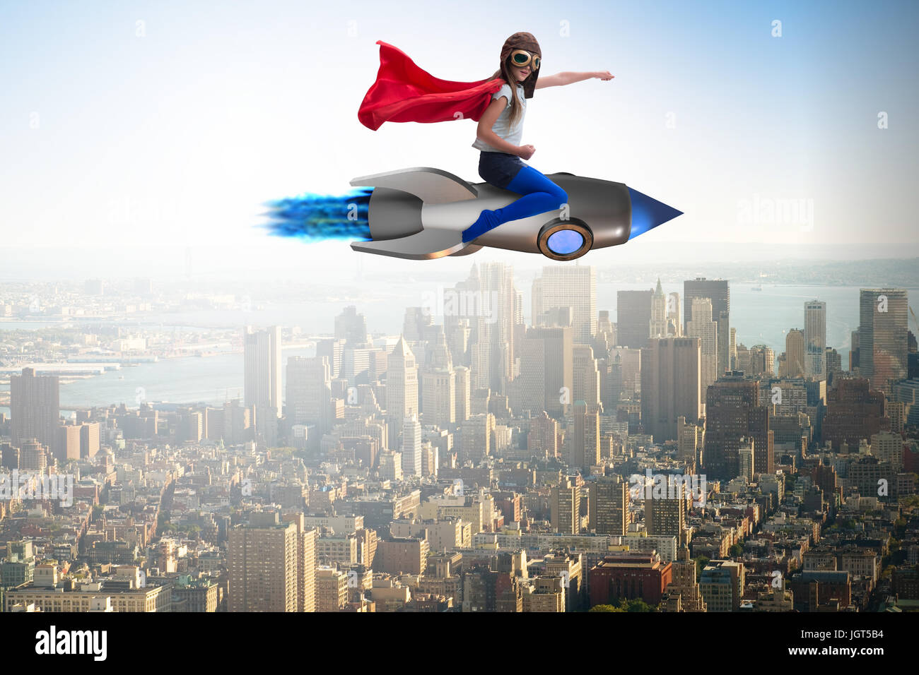 Little girl flying rocket in superhero concept Stock Photo - Alamy