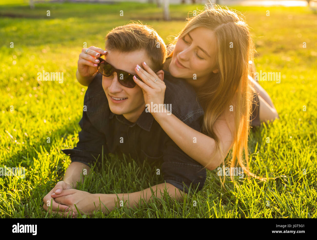 Young teenager couple have fun in a meadow Stock Photo - Alamy