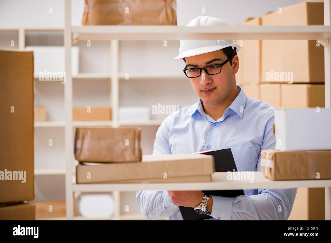 Man working in postal parcel delivery service office Stock Photo - Alamy