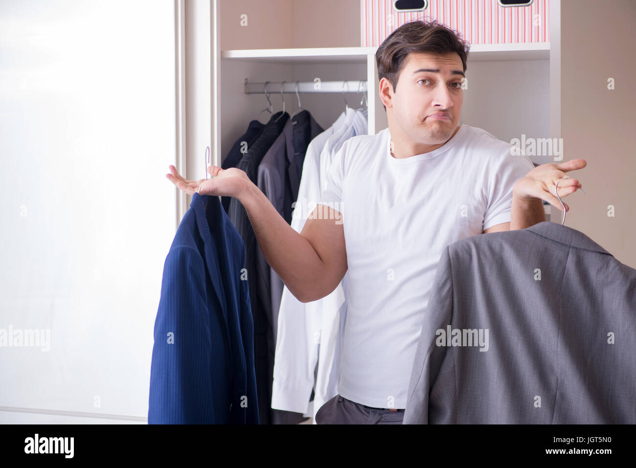 Young man businessman getting dressed for work Stock Photo - Alamy
