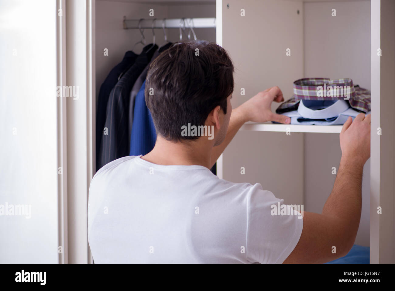 Young man businessman getting dressed for work Stock Photo - Alamy